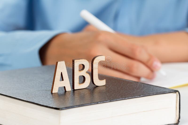 Boy Writes in a School Notebook, Wooden Letters ABC on the Book Stock ...