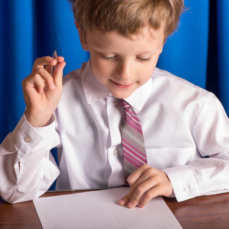 Boy Writes on a Sheet of Paper Stock Photo - Image of writing ...