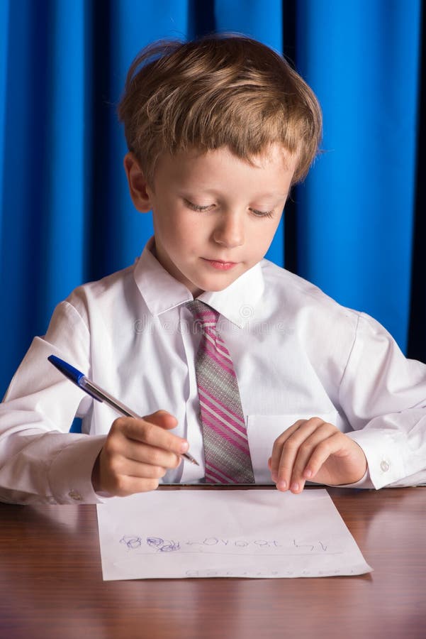 Boy Writes on a Sheet of Paper Stock Photo - Image of student, people ...