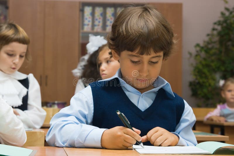 The Boy Writes To Writing-books Stock Photo - Image of classroom ...
