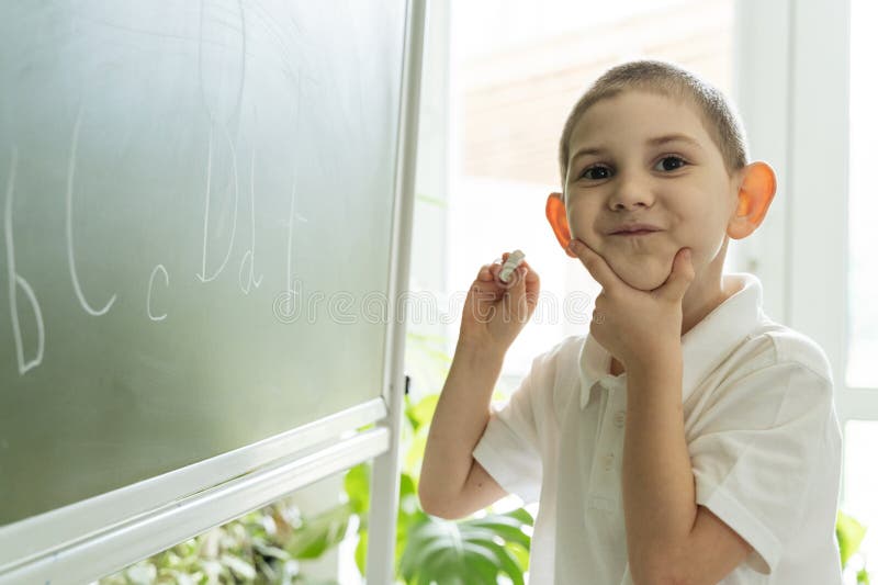 Boy Writing Abc Letters on the Green Chalkboard Stock Image - Image of ...