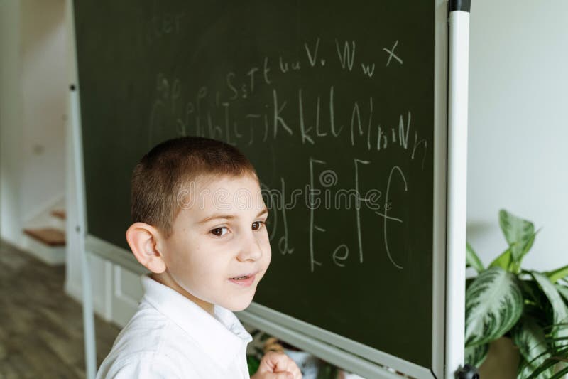 Boy Writing Abc Letters on the Green Chalkboard Stock Image - Image of ...
