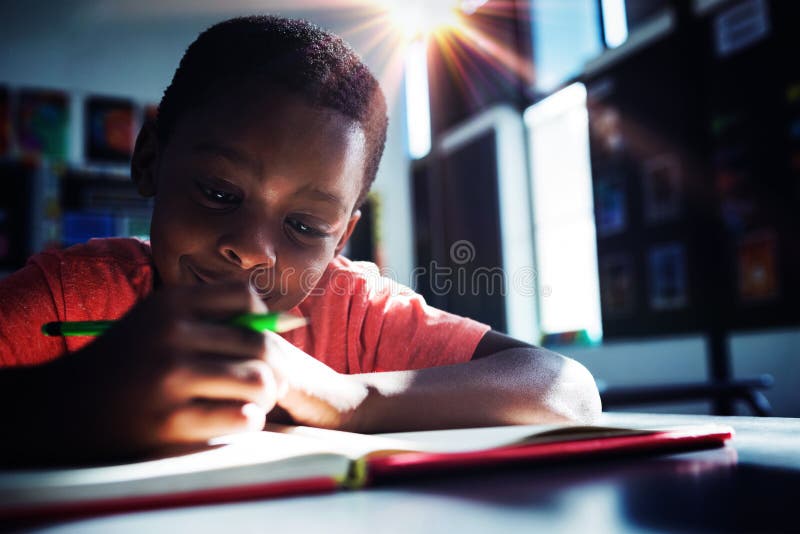 Boy writing in book stock photo. Image of development - 118700538