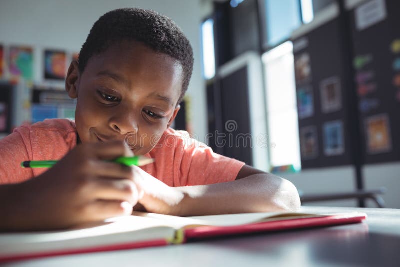 Boy writing in book stock image. Image of child, light - 96121427