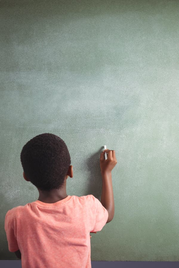 Boy Writing with Chalk on Greenboard Stock Photo - Image of rear ...