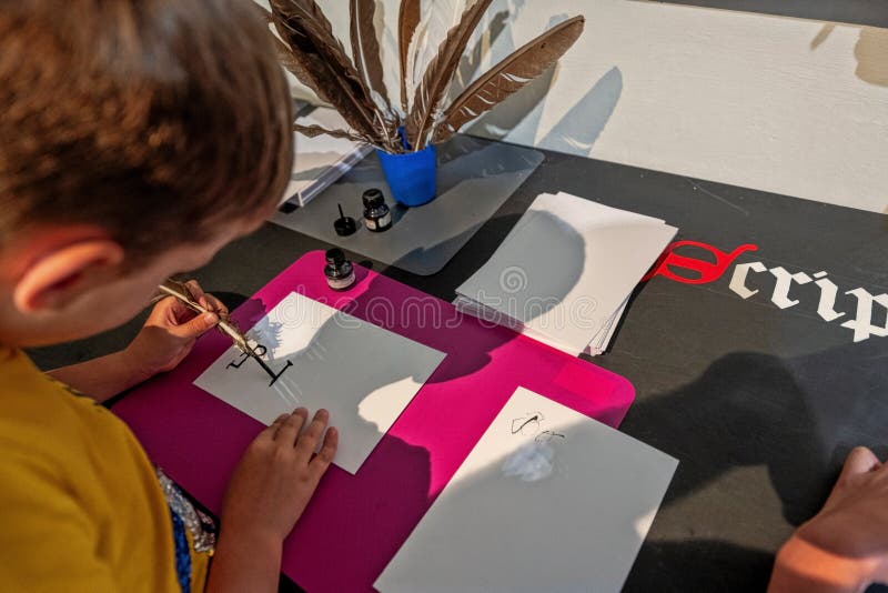 Boy Writing with Feather Quill Pen at Desk Stock Photo - Image of sheet ...