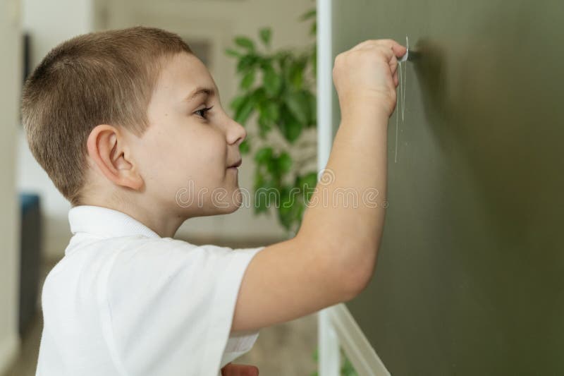 Boy Writing Abc Letters on the Green Chalkboard Stock Image - Image of ...
