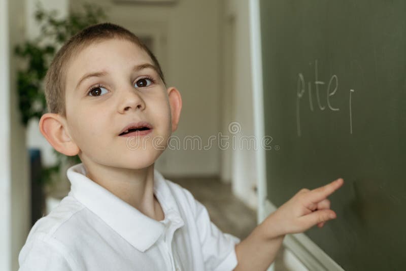 Boy Writing His Name on the Green Chalkboard Stock Photo - Image of ...