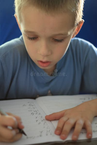 Boy writing homework stock photo. Image of table, learning - 781494