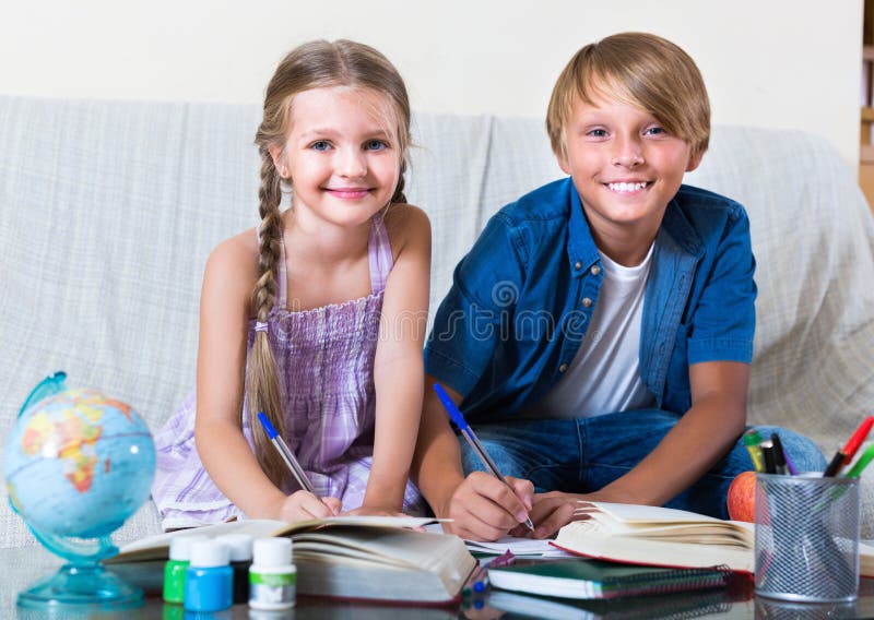 Boy Writing Homework with Little Sister Stock Image - Image of pupil ...