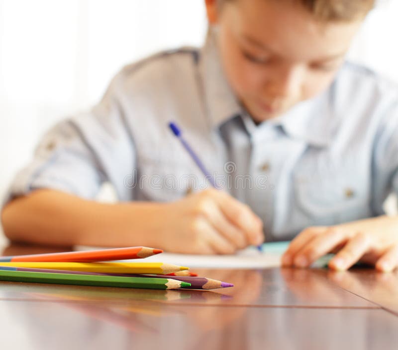 Boy writing in notebook stock photo. Image of people - 25786974