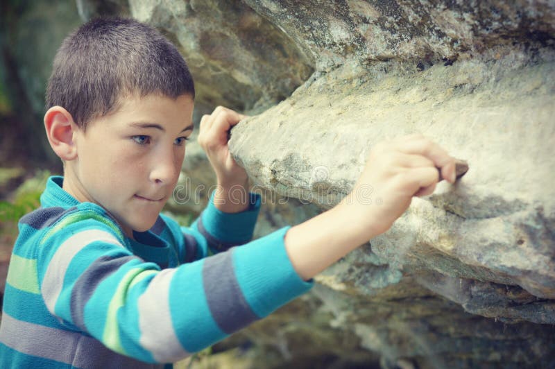 Boy Writing on Rock with a Stone Stock Image - Image of stone, outdoors ...