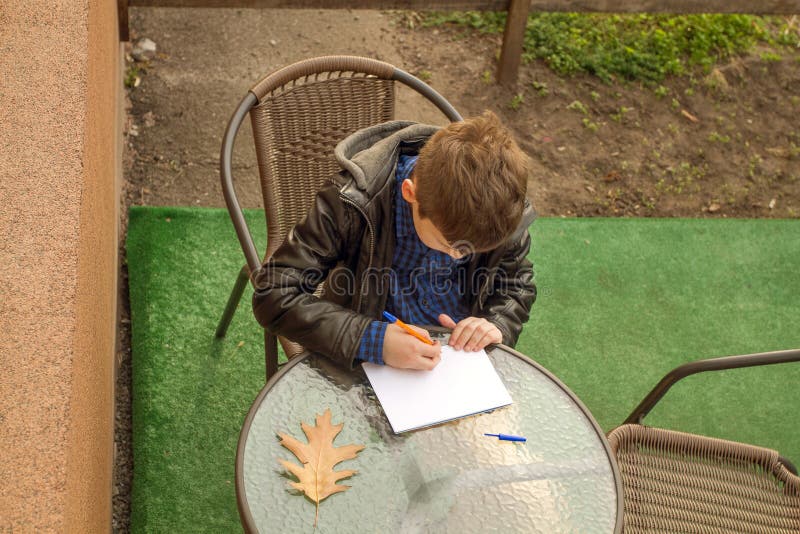 Boy is Doing Homework Outdoors Stock Photo - Image of concentrate ...