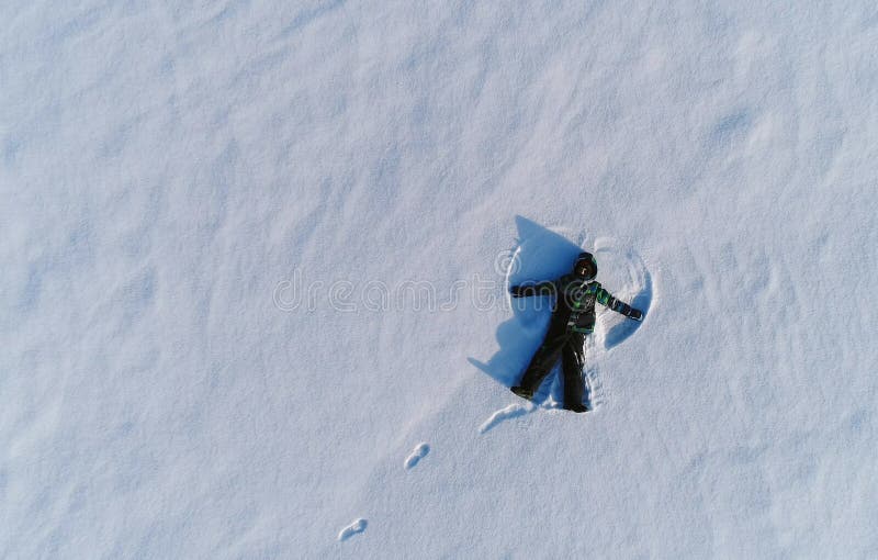 Boy of 7 Years Makes Snow Angel in Snow Area. Aerial Foto. Stock Image ...