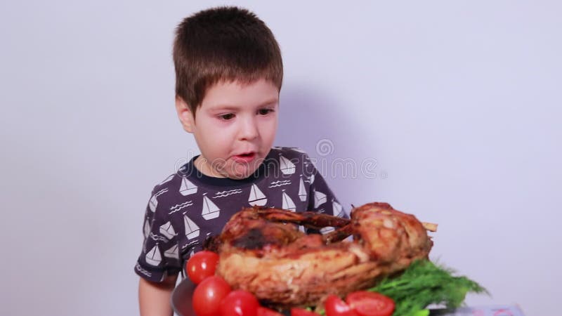 A Boy of 3-4 Years Old Eats Rabbit Meat. Proper Nutrition for Children ...