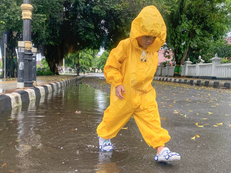 Boy in Yellow Raincoat Playing in Park Stock Image - Image of rainy ...