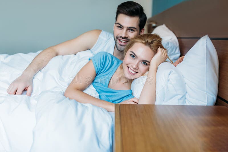 Boyfriend and Girlfriend Lying in Bed and Looking Stock Image - Image ...