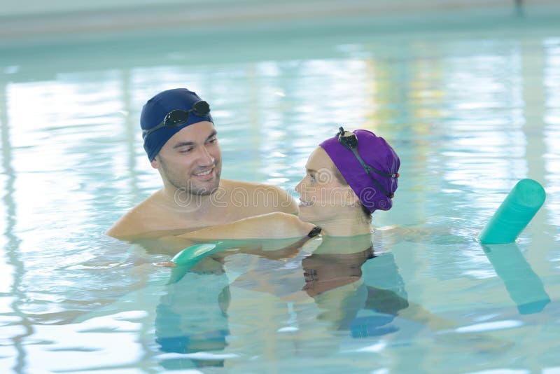 Boyfriend Teaches Girlfriend To Float in Swiming Pool Stock Image ...