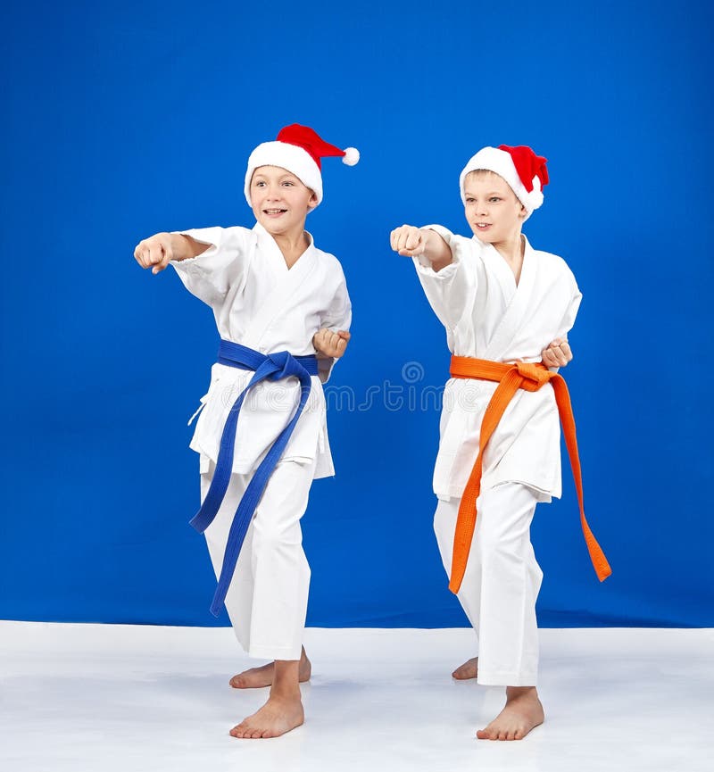 The Boys in Caps of Santa Claus Hit Punch Hand Stock Image - Image of ...