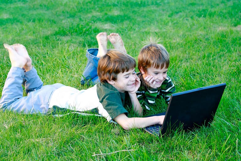 Boys on Computer stock image. Image of american, grass - 4113051