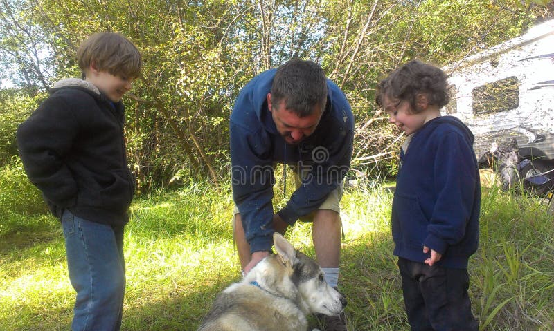 Boys and dad petting dog editorial photo. Image of visiting - 44884256