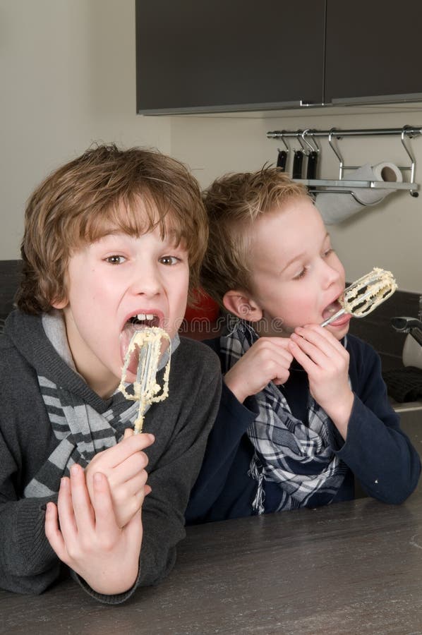 Boys Eating Dough from a Beater Stock Photo - Image of kitchen ...