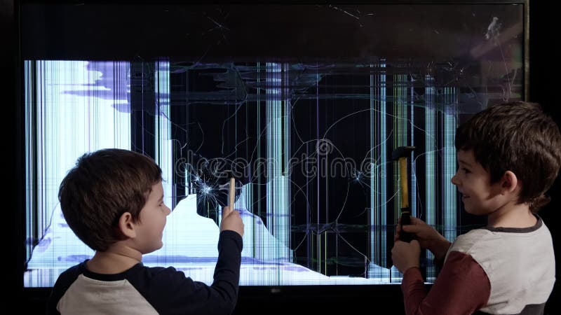 Boys Entertaining Using Hammers Looking at a Broken TV Screen Stock ...