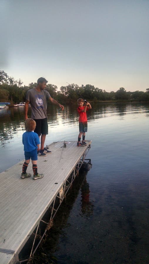 Boys on a Fishing Dock stock image. Image of horizontal - 4628029