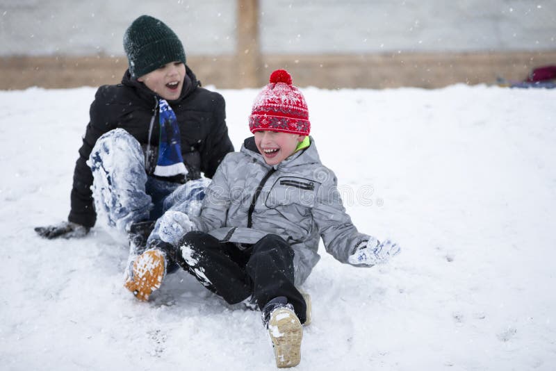 Boys friends are sledding stock photo. Image of brother - 243192074