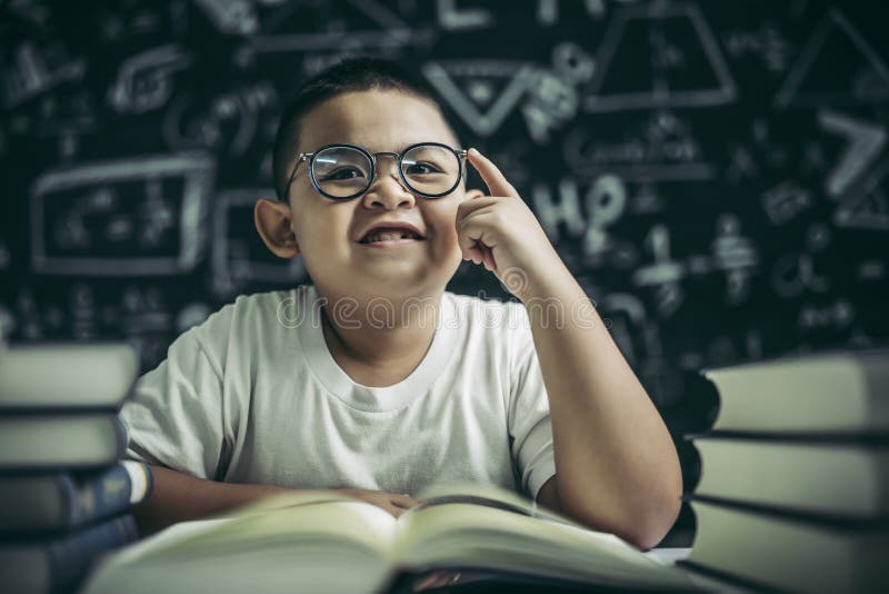 Boys with Glasses Write Books and Think in the Classroom Stock Photo ...