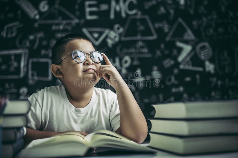 Boys with Glasses Write Books and Think in the Classroom Stock Image ...