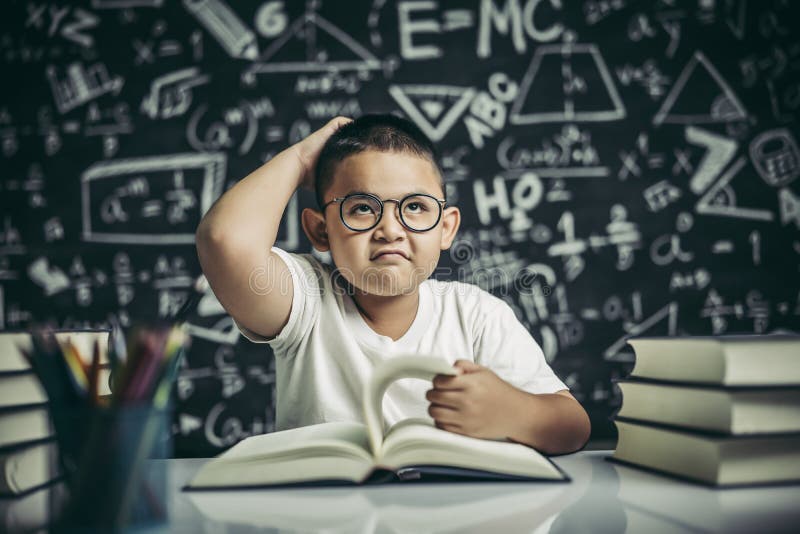 Boys with Glasses Write Books and Think in the Classroom Stock Photo ...