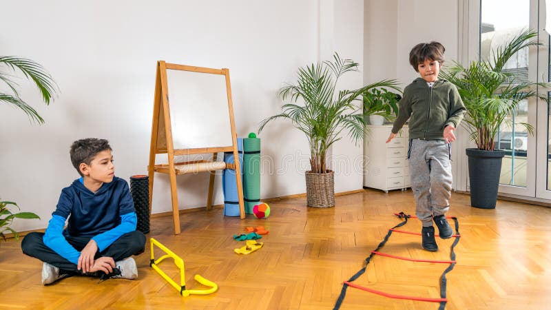 Boys Jumping Over Ladders stock image. Image of child - 211216693