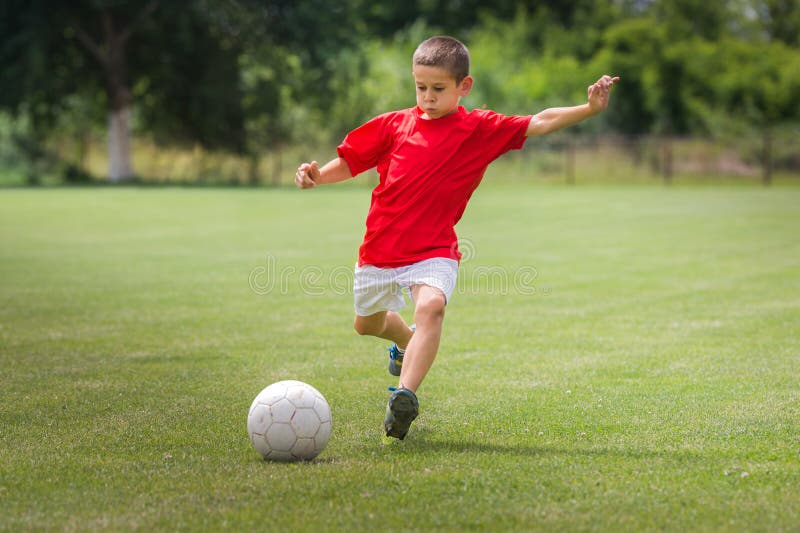 Boys kicking ball stock image. Image of motion, shooting - 73276673