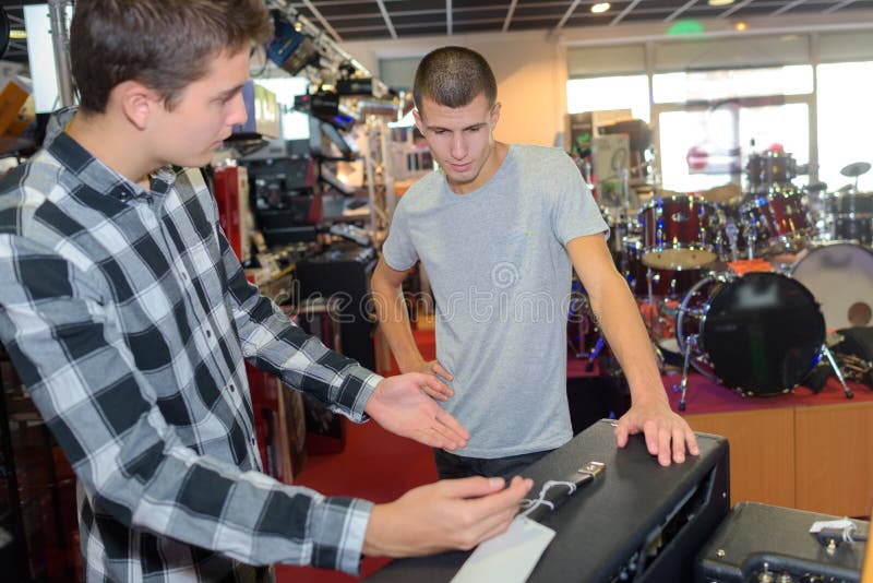 Boys in music store stock photo. Image of passion, store - 186439258