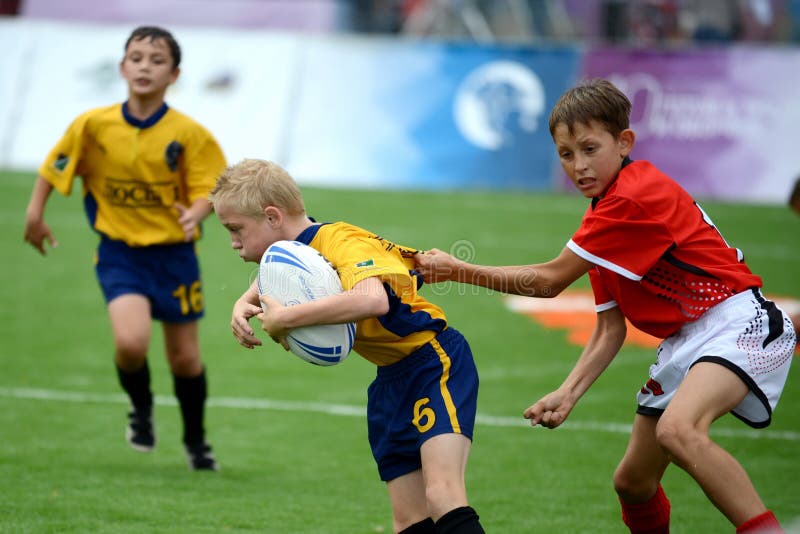 The boys play Rugby editorial photography. Image of field - 82390237