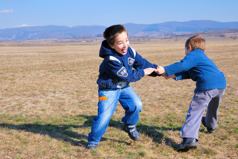 Boys playing stock image. Image of happiness, holding - 4195907