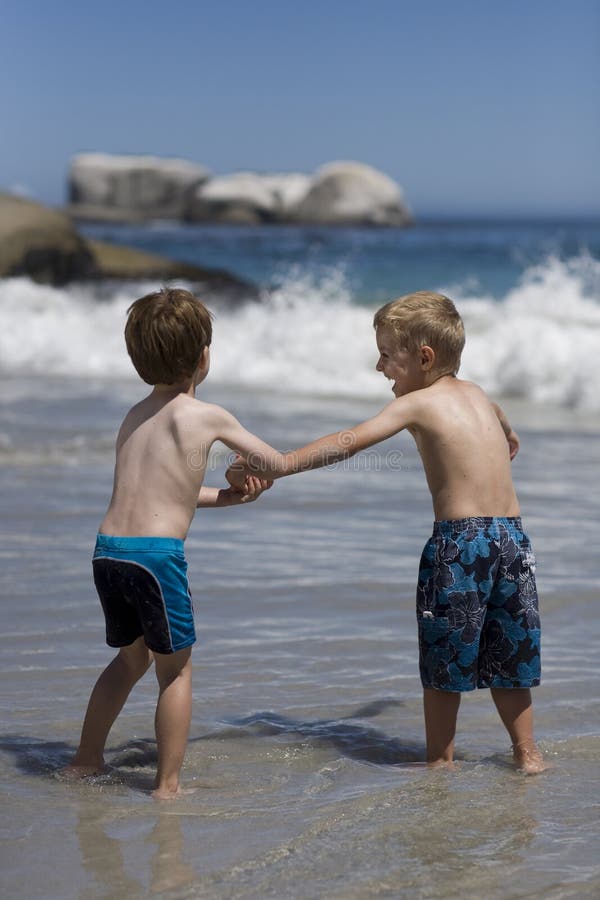 Boys playing on the beach stock image. Image of beach - 24732239