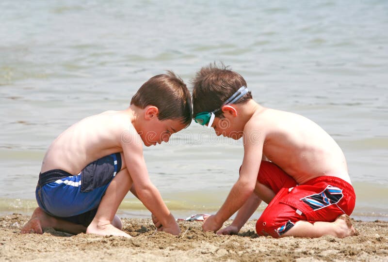 Boys Playing at the Beach stock photo. Image of close - 4569114