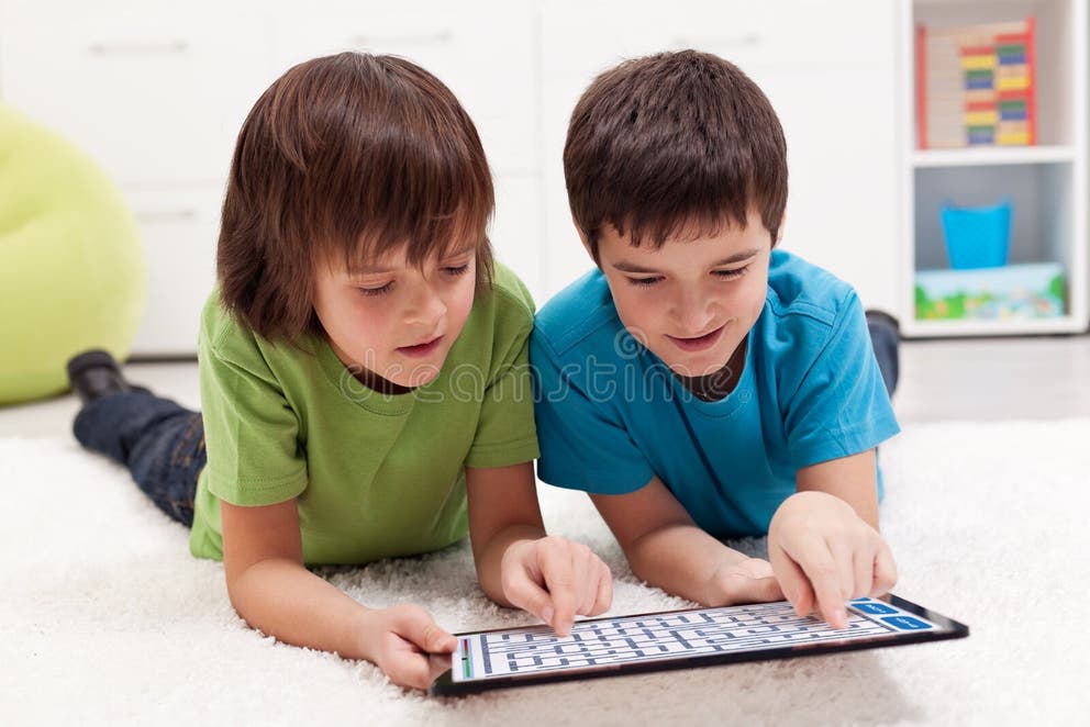 Boys Playing Labyrinth Game on Tablet Computer Stock Image - Image of ...
