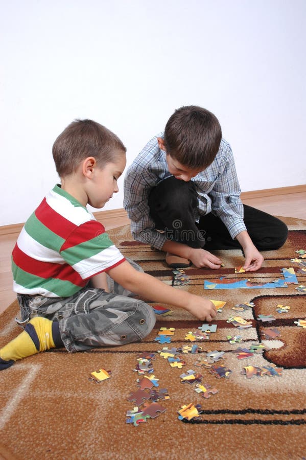 Boys playing the puzzle stock photo. Image of male, sitting - 11588626