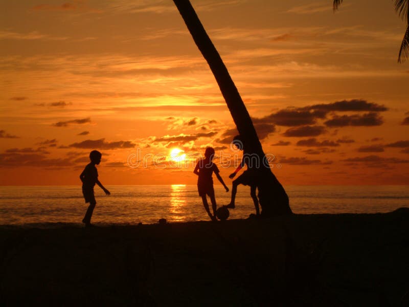 Boys Playing at sunset stock image. Image of island, beach - 139167