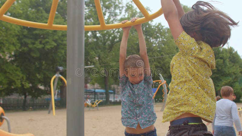Boys Spinning on the Playground. Developing Vestibular System. Stock ...
