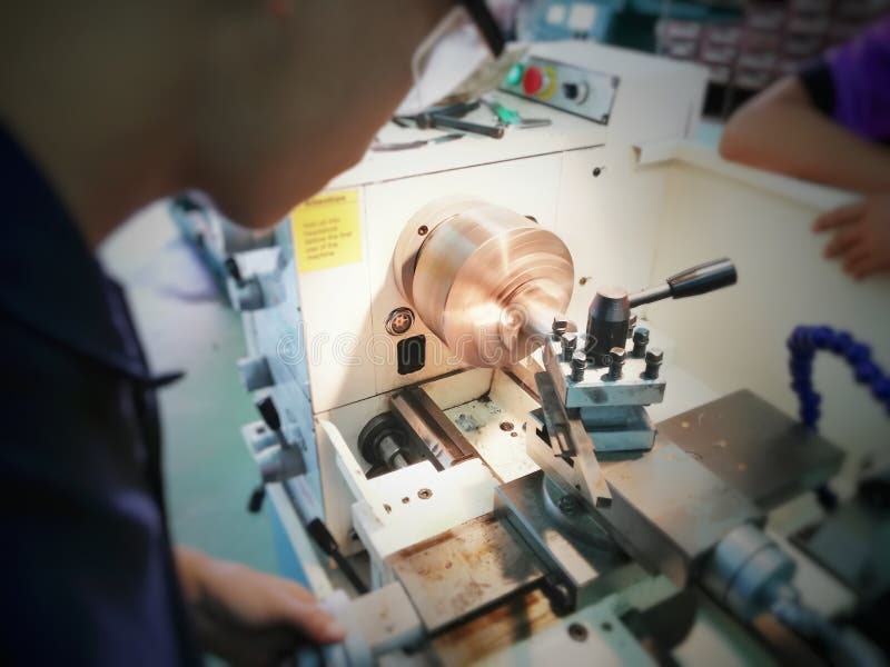 The Boys are Turning the Lathe To Iron the Iron into a Work Piece Stock ... The Boys are Turning the Lathe To Iron the Iron into a Work Piece Stock ...