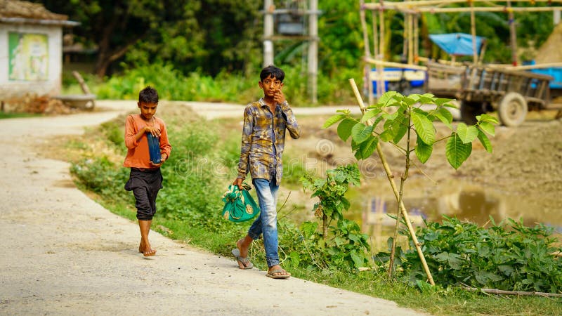 Boys walk on the road editorial photo. Image of human - 268928496