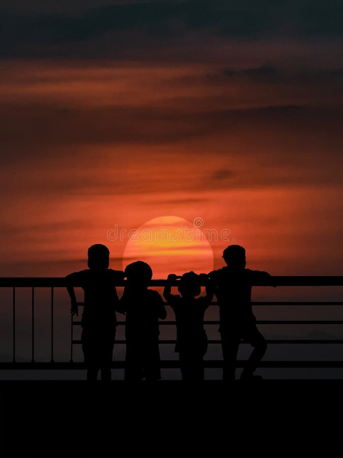 Boys Watching the Sunset at the Boardwalk Stock Image - Image of ...