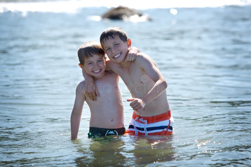 Boys in water stock photo. Image of cute, coast, standing - 15464226