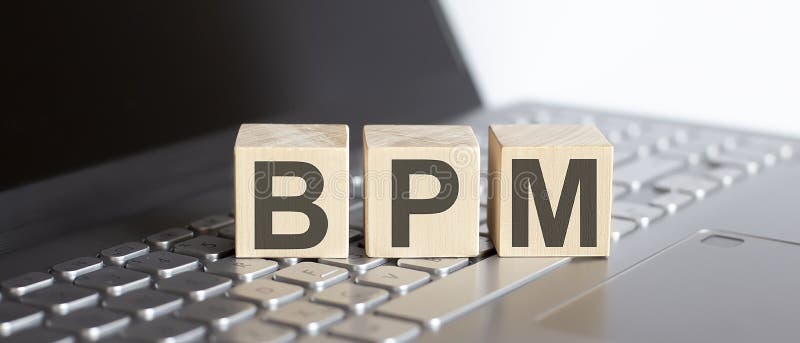 BPM Business Process Management Written on a Wooden Cube on Laptop ...