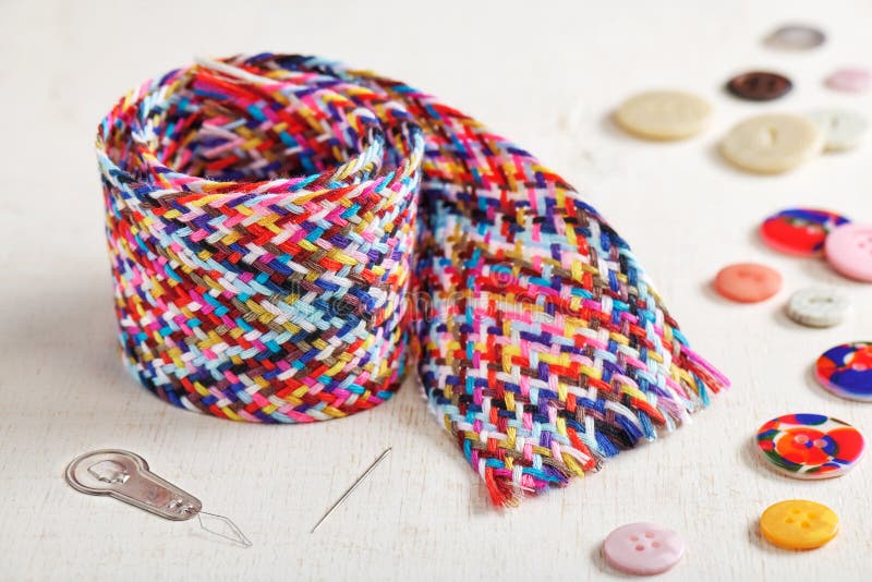 A Braid of Multi Colored Sewing Threads, Needle, Needle Threader ...
