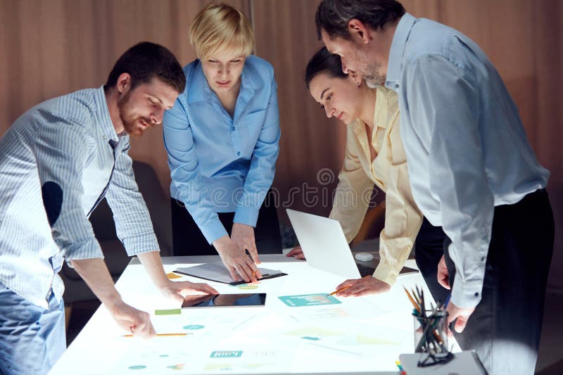 CEO Doing Presentation for Young Team Entrepreneurs, Using Laptop with ...